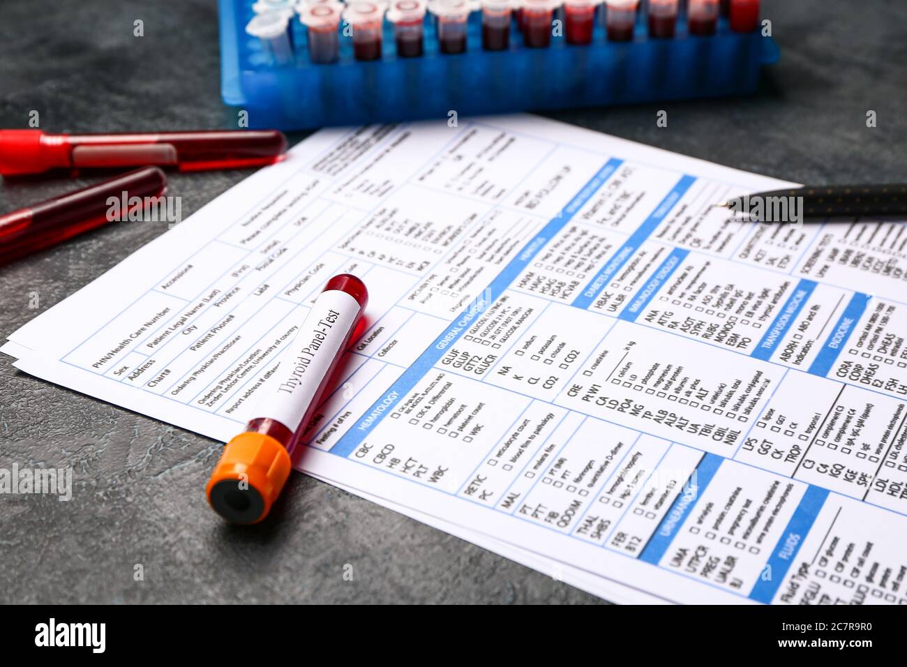 Blood samples in tubes and laboratory test form on dark background ...