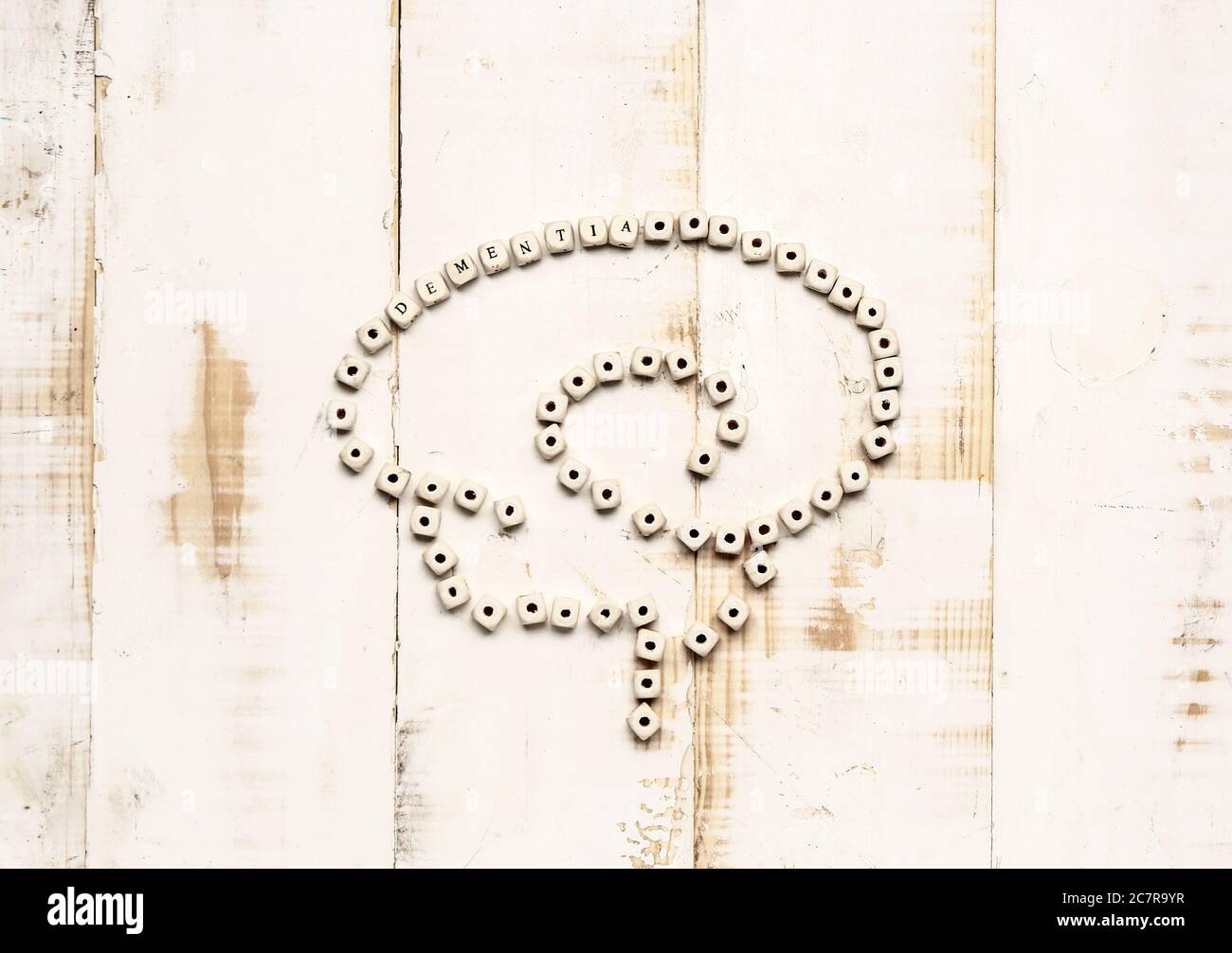 Human brain made of beads on white wooden background. Concept of ...