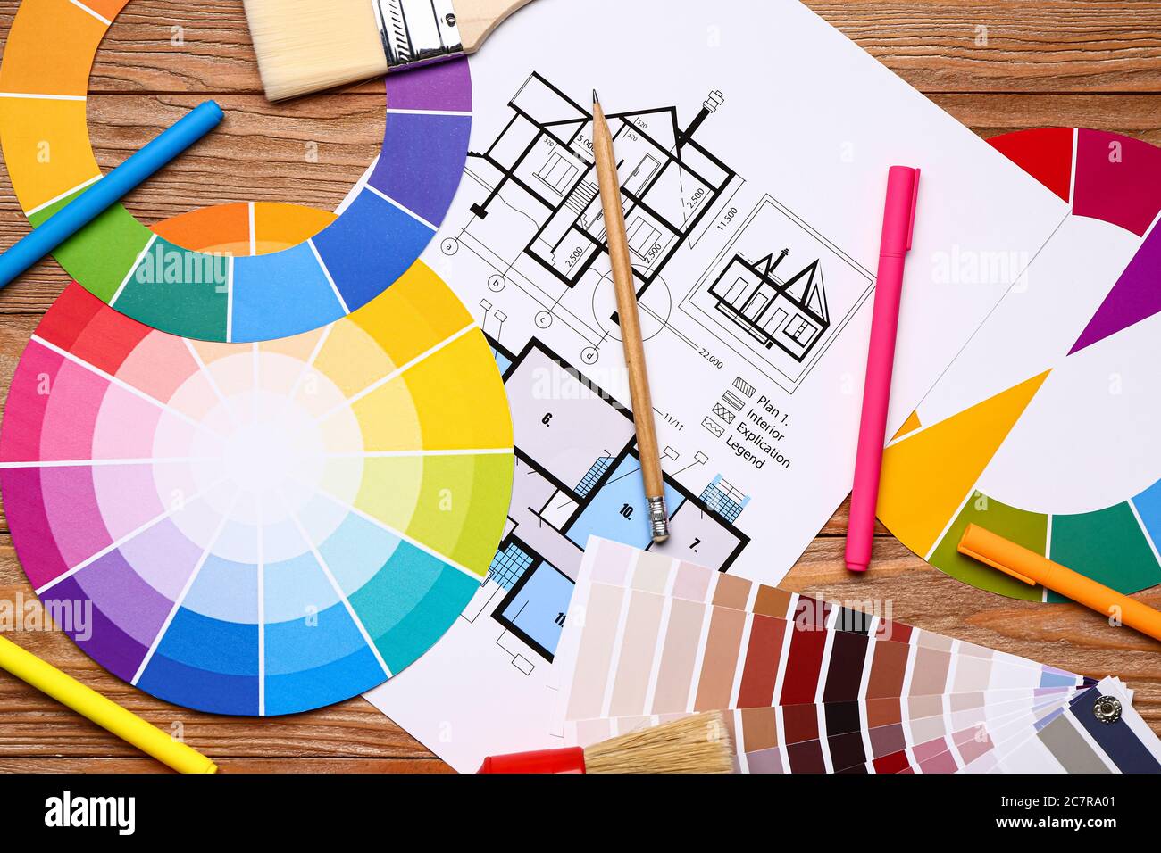 Color palettes with paint brush and building plan on wooden background ...