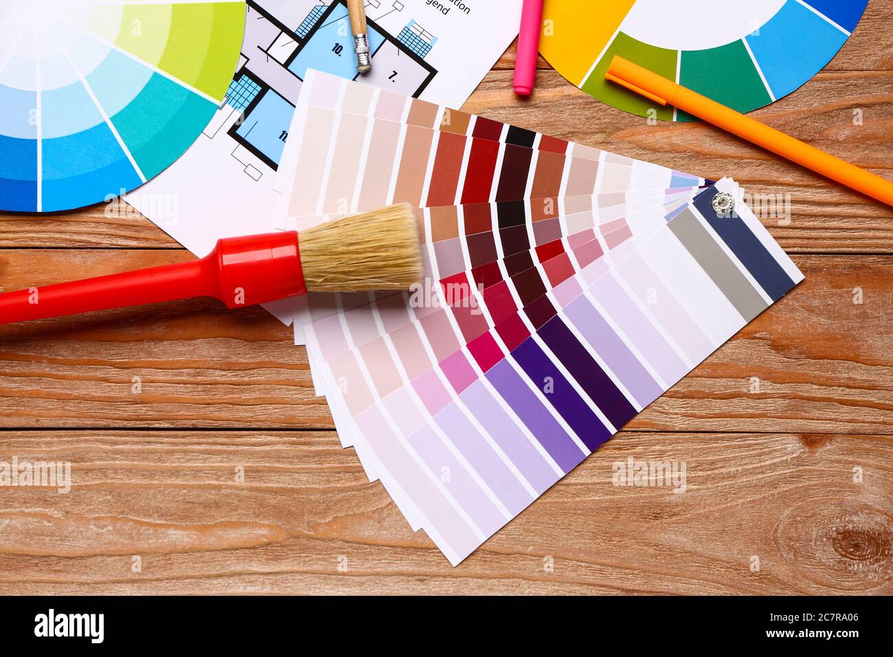Color palettes with paint brush and building plan on wooden background ...