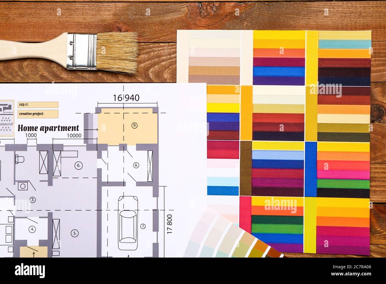 Color palettes with paint brush and building plan on wooden background ...