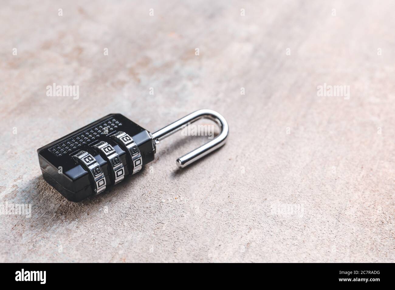 Small lock on grey background Stock Photo - Alamy