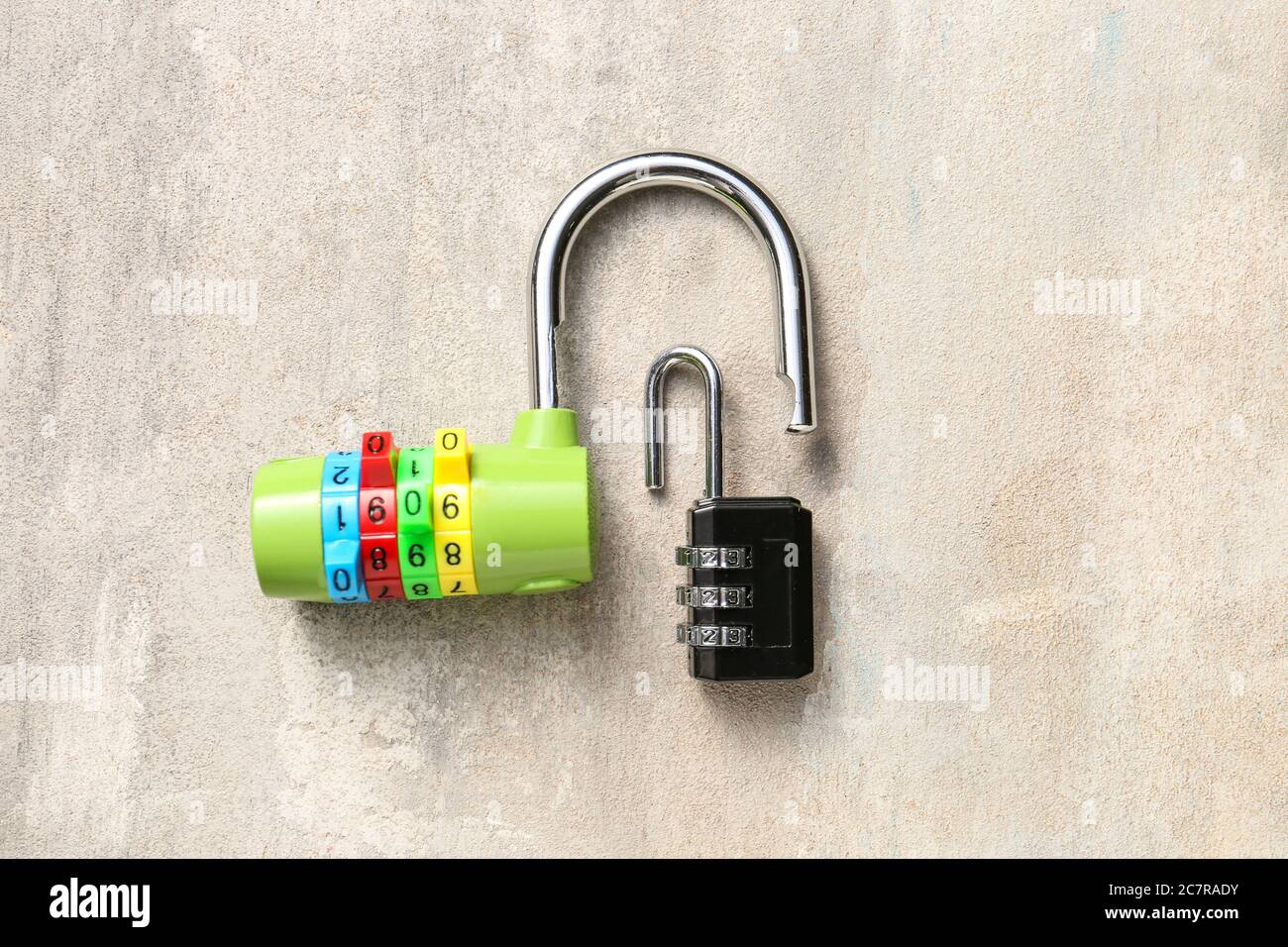 Small locks on grey background Stock Photo - Alamy