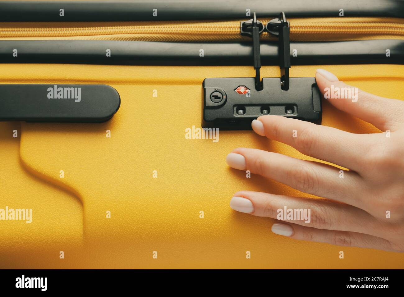 Woman opening lock on suitcase, closeup Stock Photo - Alamy