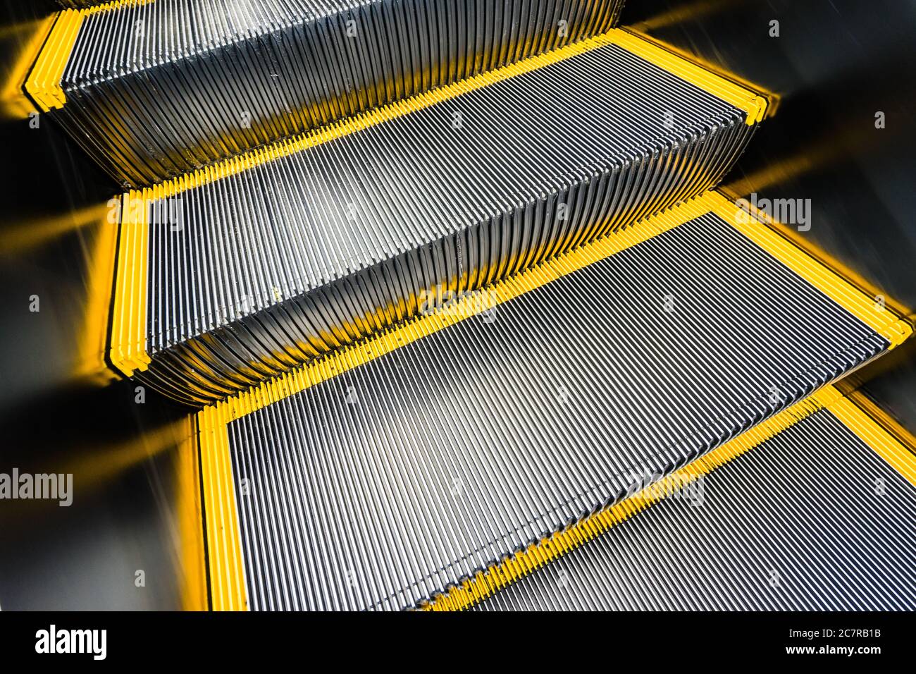 Silver escalator yellow stripes steps hi-res stock photography and ...