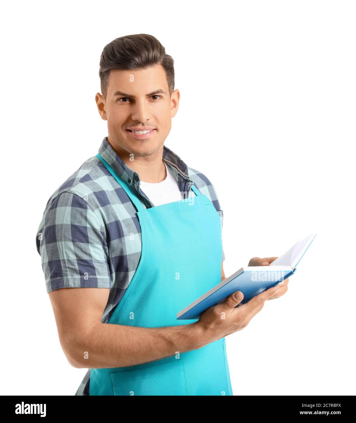 Young man with recipe book on white background Stock Photo - Alamy