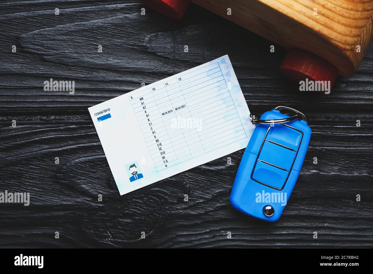 Driving license with car key on dark wooden background Stock Photo - Alamy