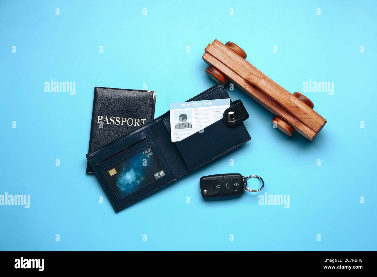 Driving license with wallet, passport and car key on color background ...