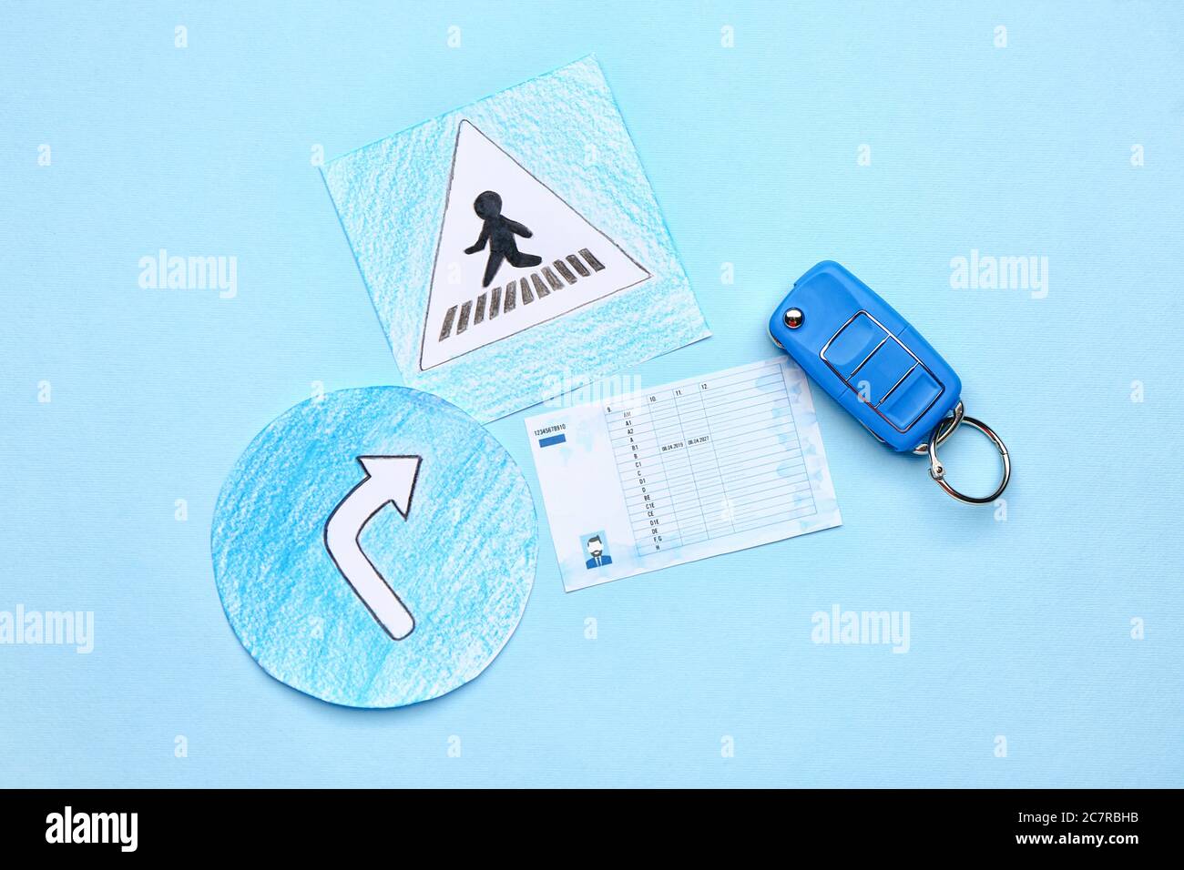 Driving license with car key and road signs on color background Stock ...