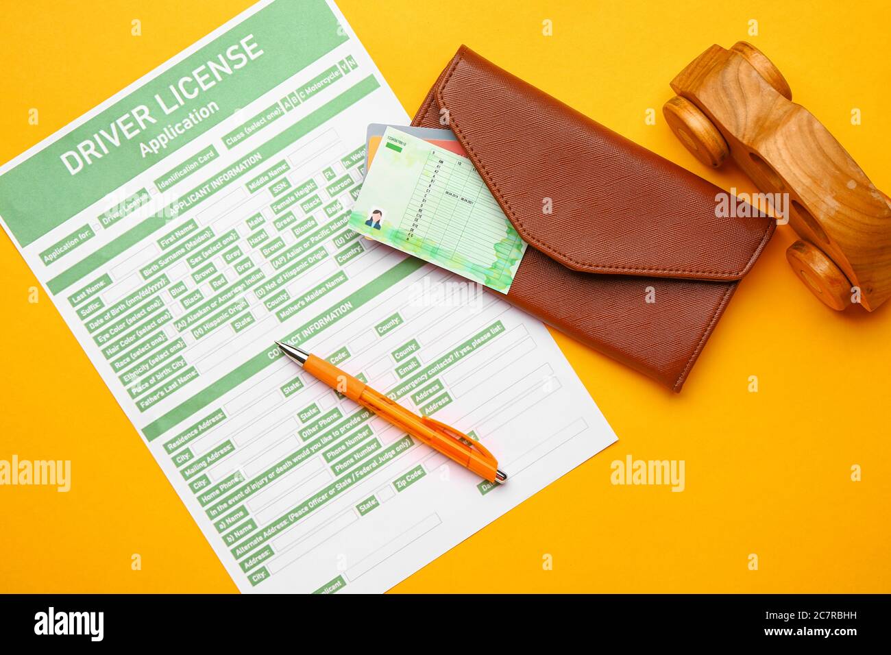 Driving license with application form and wallet on color background ...