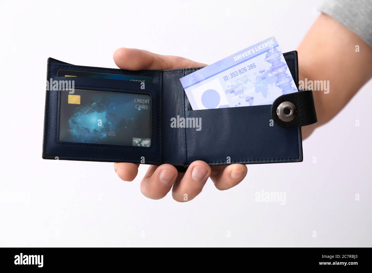 Male hand with driving license in wallet on white background Stock ...