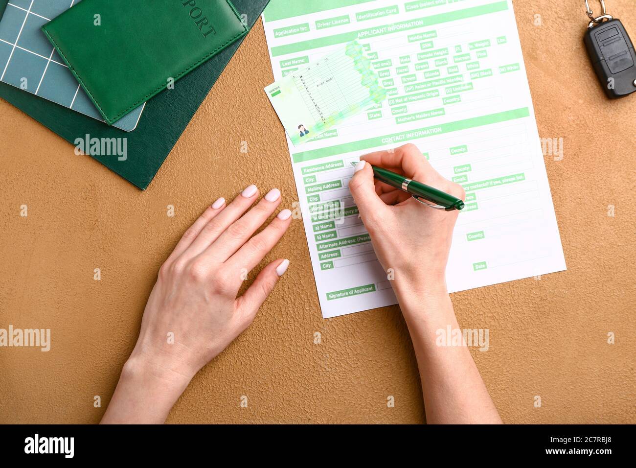 Woman filling in driver license application at table Stock Photo - Alamy