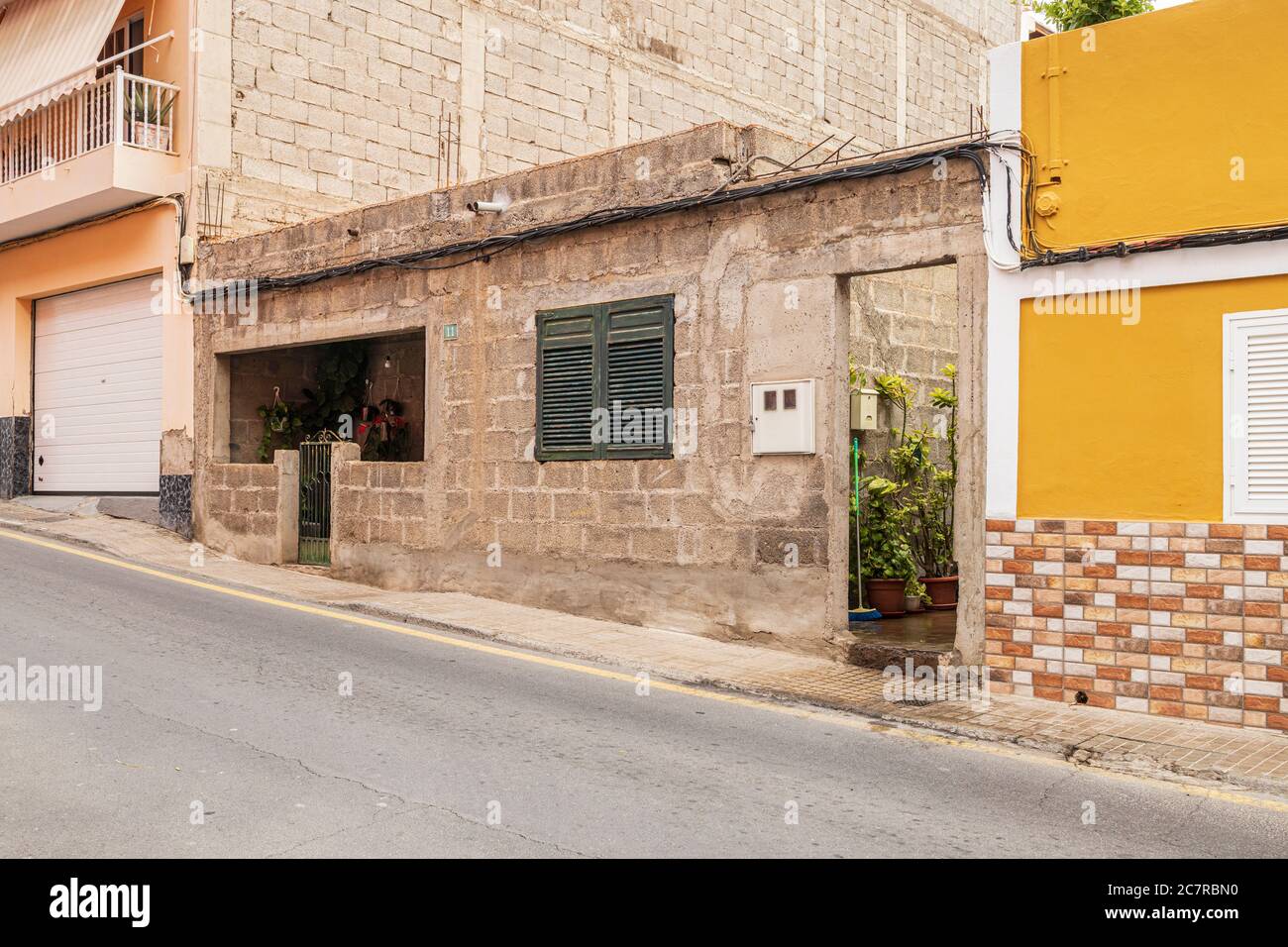 Unrendered brick and concrete built single storey house with lots of ...