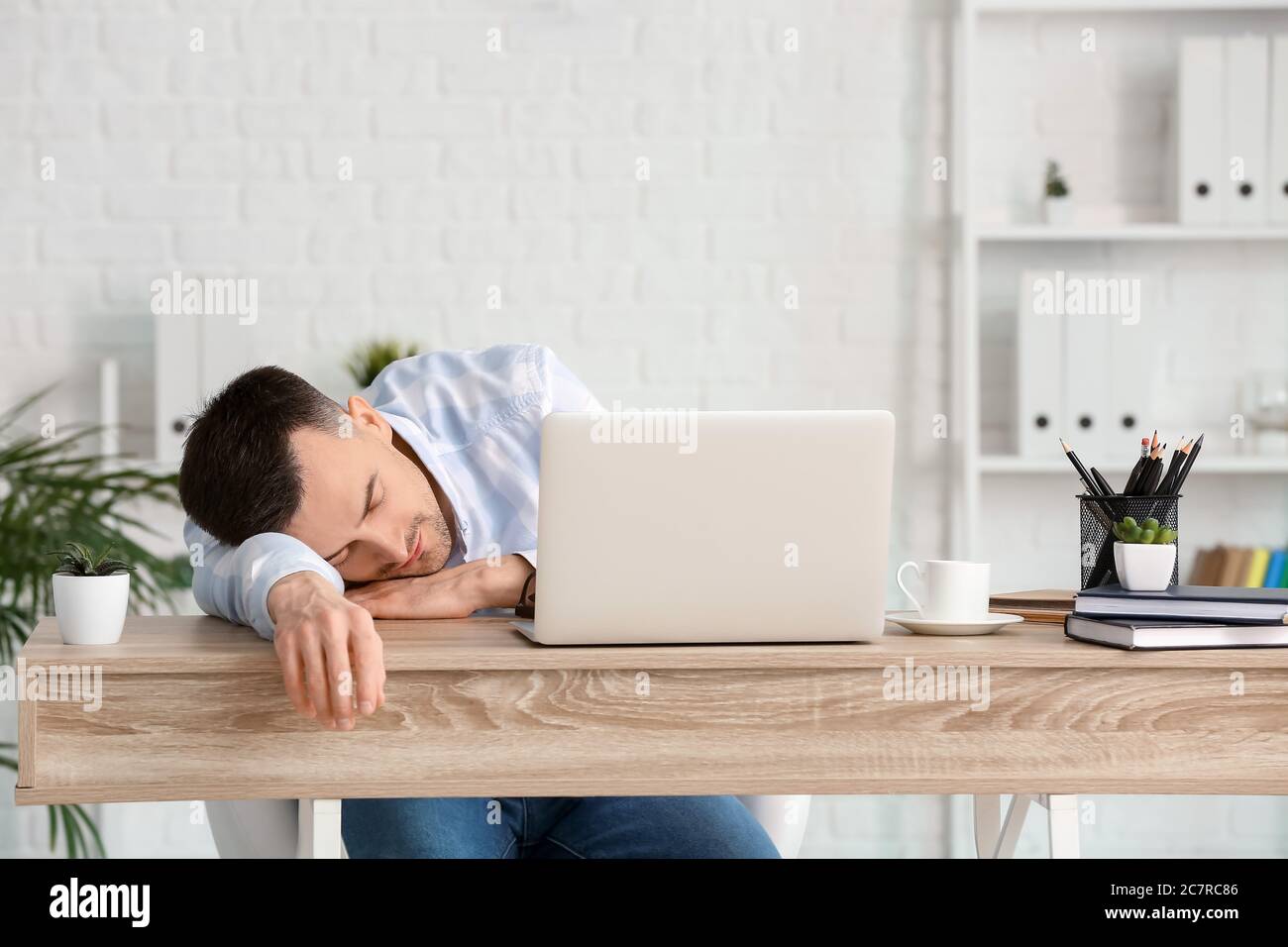 Young man falling asleep during work in office. Concept of sleep ...