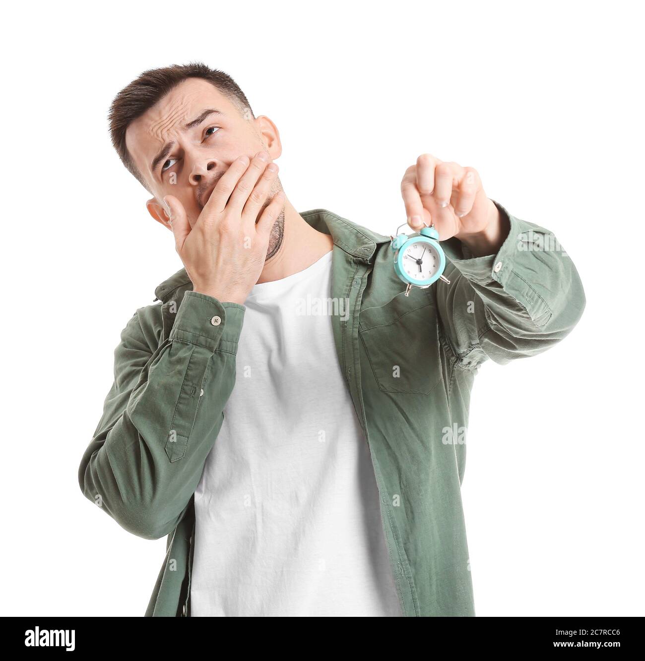 Tired man with alarm clock on white background. Concept of sleep ...