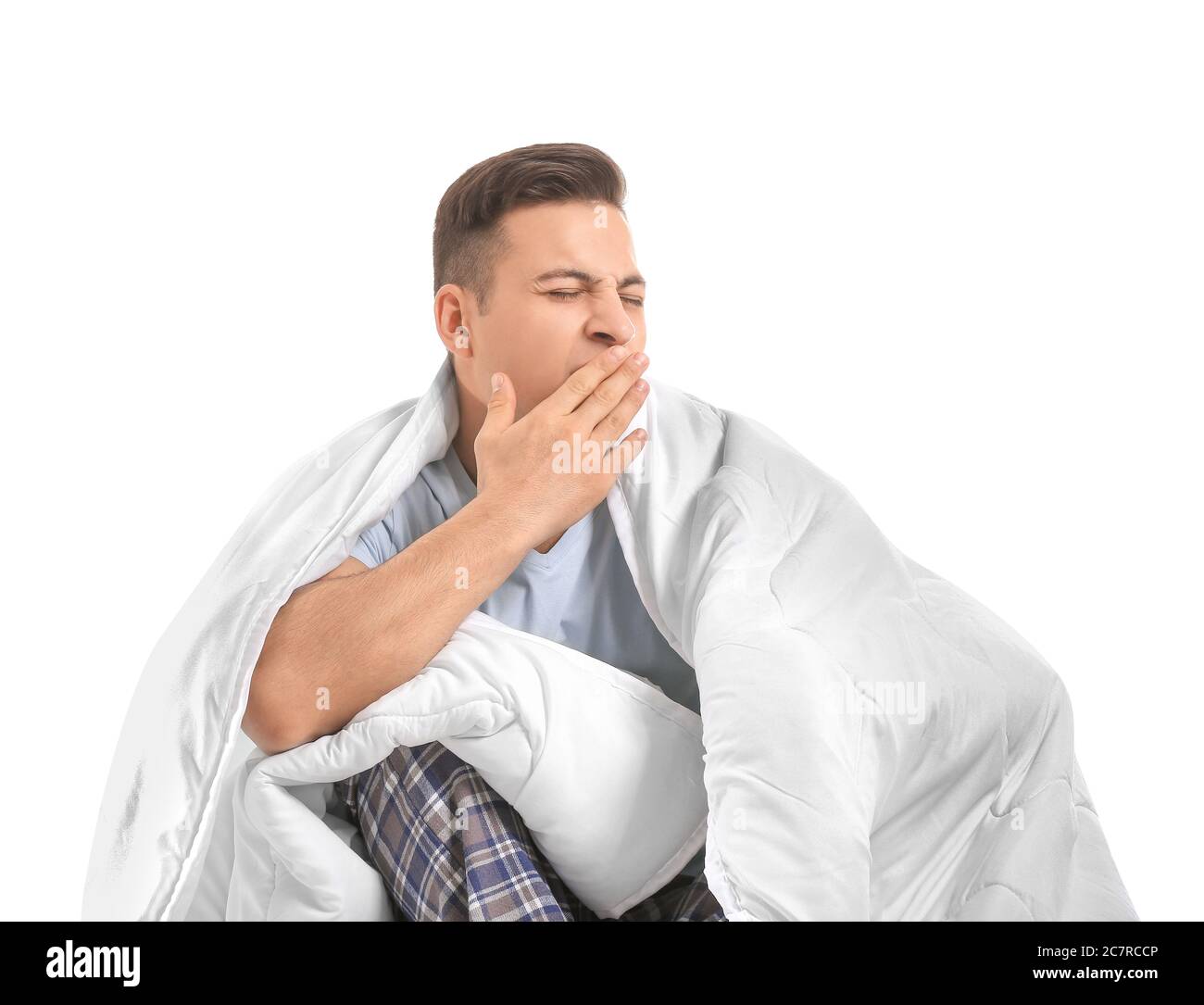 Tired man with blanket on white background. Concept of sleep ...