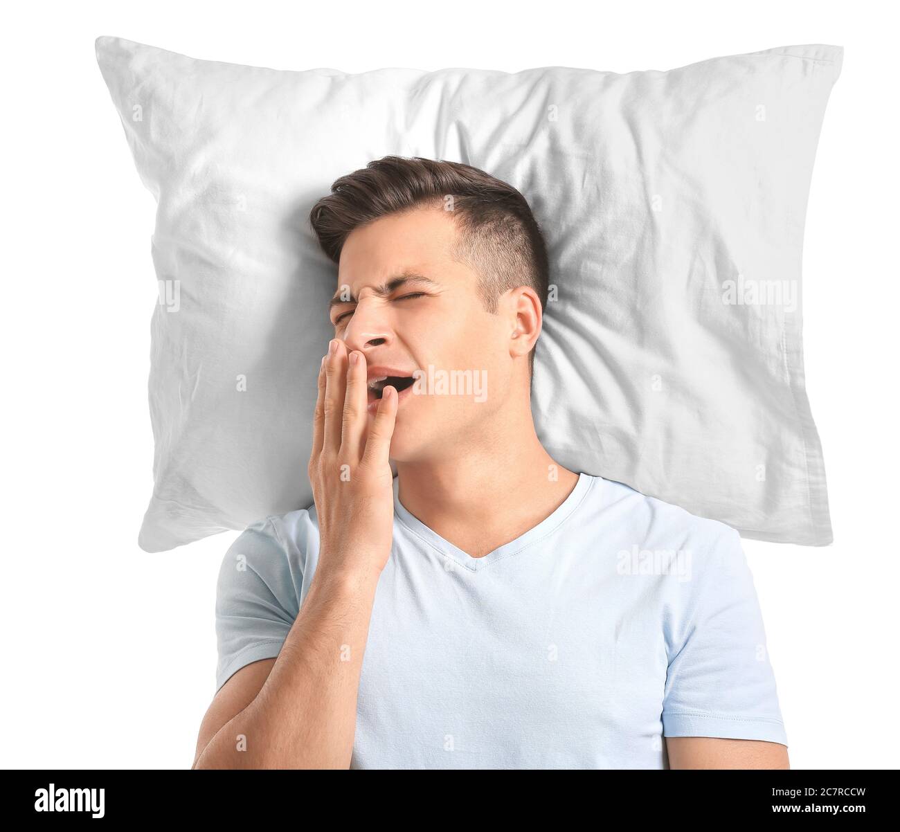 Tired man with pillow on white background. Concept of sleep deprivation ...