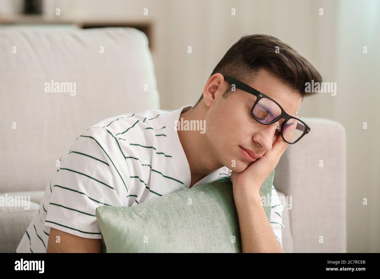 Young man suffering from sleep deprivation at home Stock Photo - Alamy