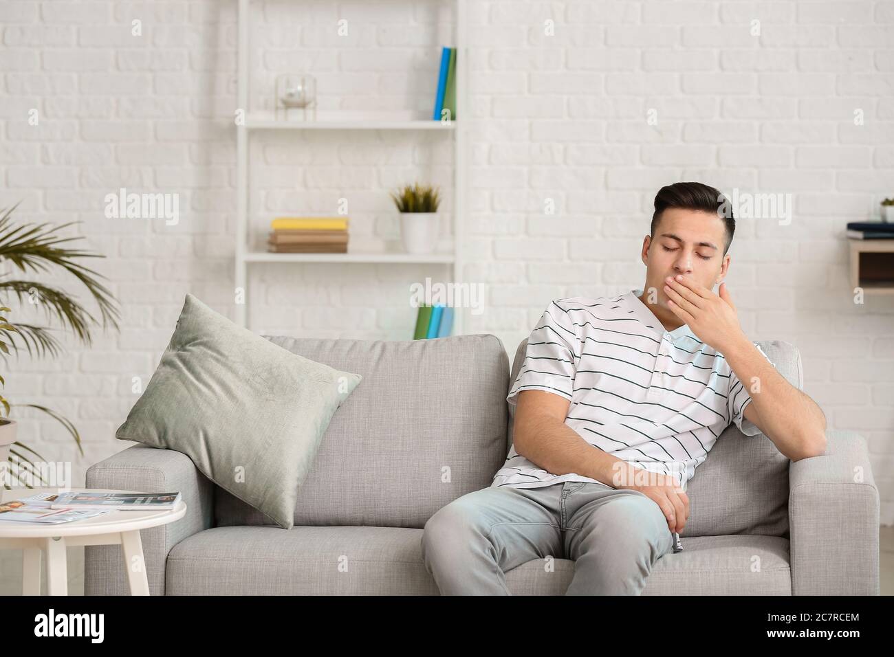 Young man suffering from sleep deprivation at home Stock Photo - Alamy
