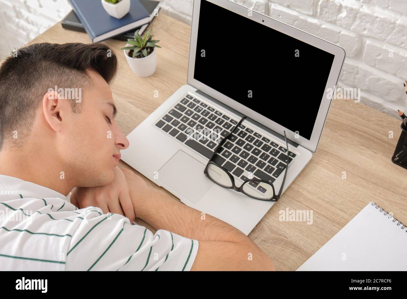 Young man falling asleep during work in office. Concept of sleep ...
