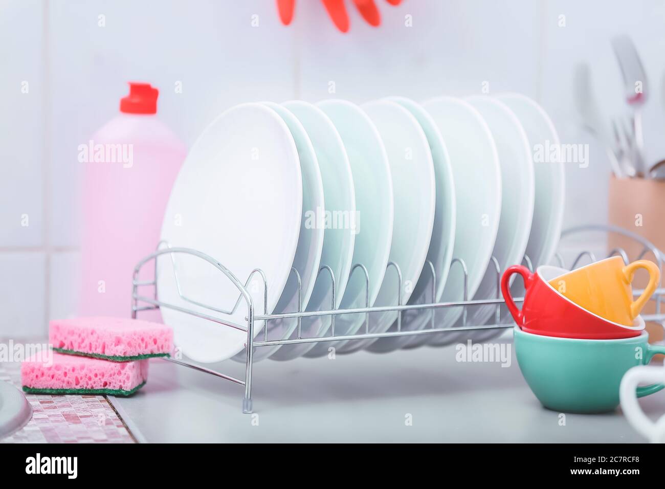 Clean dishes and detergents on kitchen table Stock Photo - Alamy