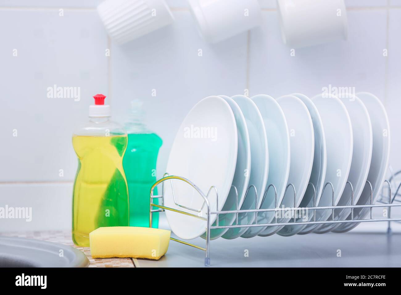 Clean dishes and detergents on kitchen table Stock Photo - Alamy