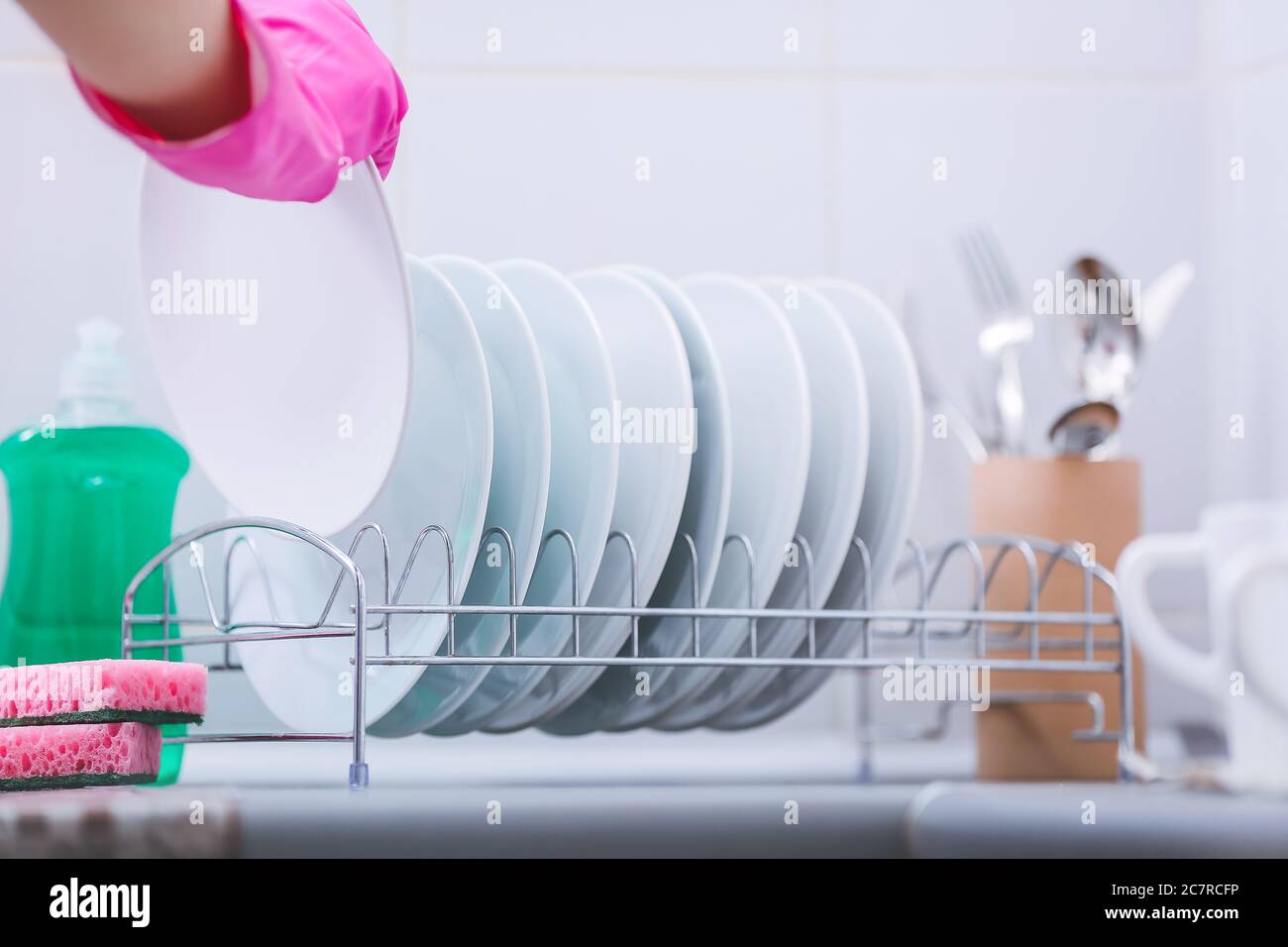 Woman washing dishes in kitchen Stock Photo - Alamy