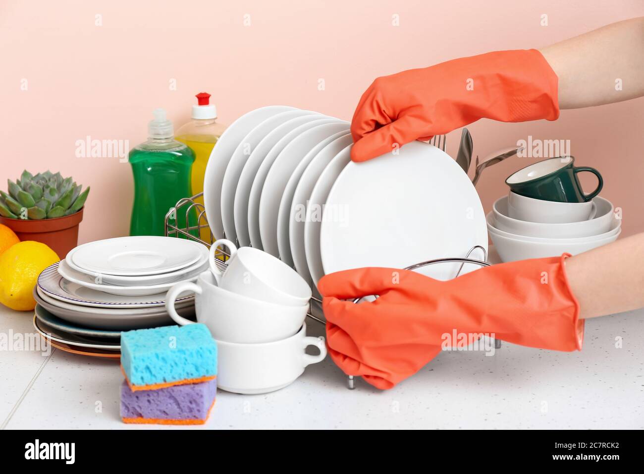 Woman washing dishes in kitchen Stock Photo - Alamy