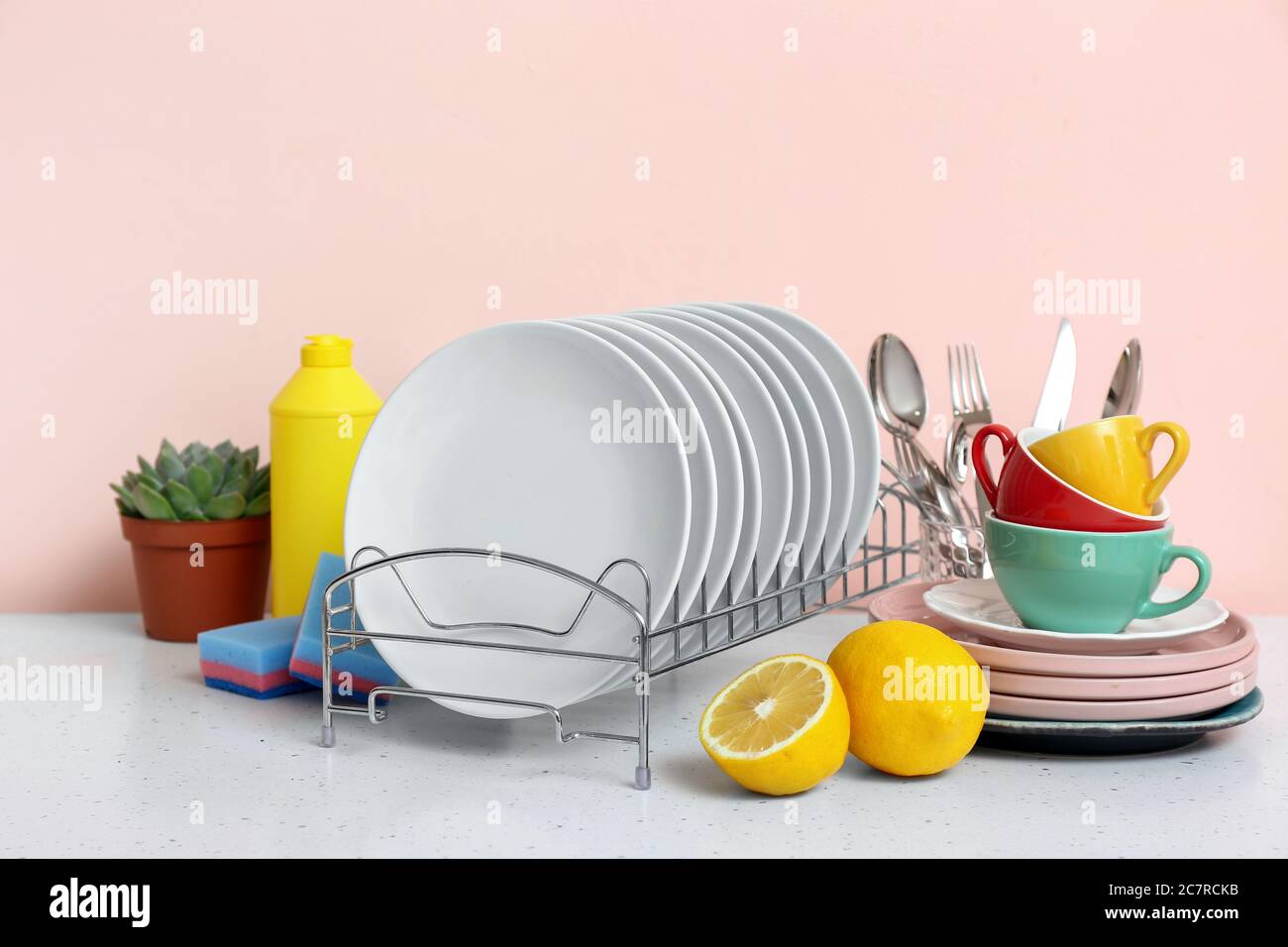 Clean dishes and detergents on kitchen table Stock Photo - Alamy