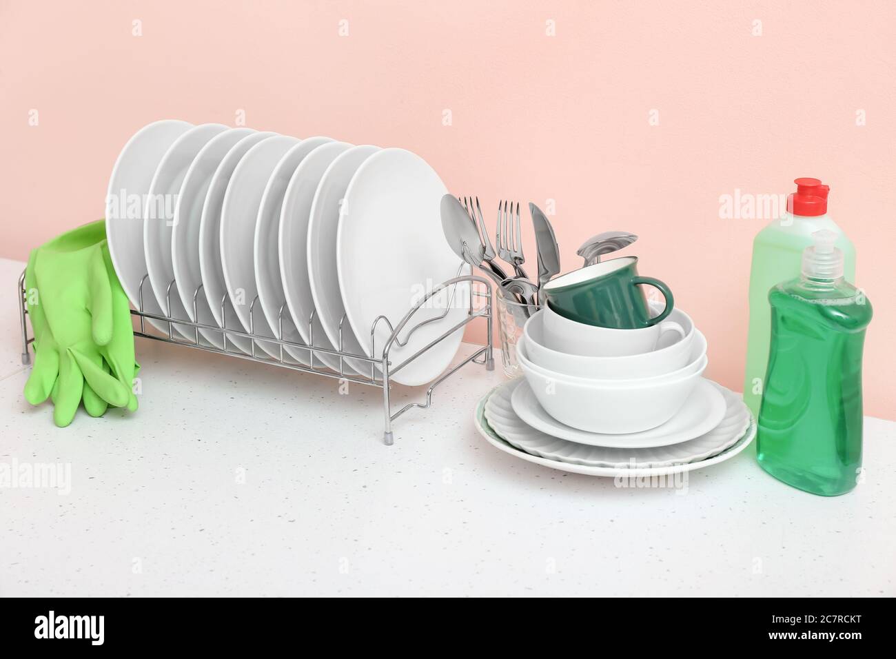 Clean dishes and detergents on kitchen table Stock Photo - Alamy