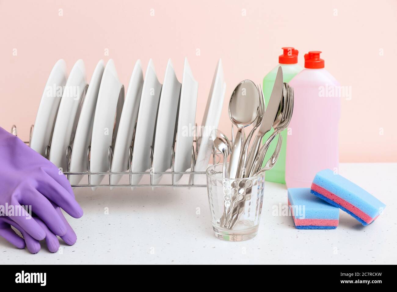 Clean dishes and detergents on kitchen table Stock Photo - Alamy