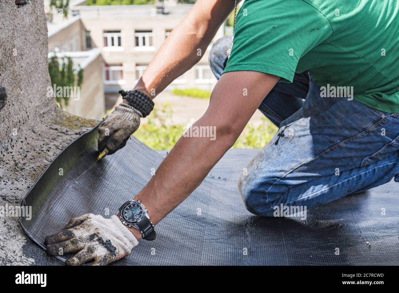 Worker performs overhaul of the roof of a residential building Stock ...