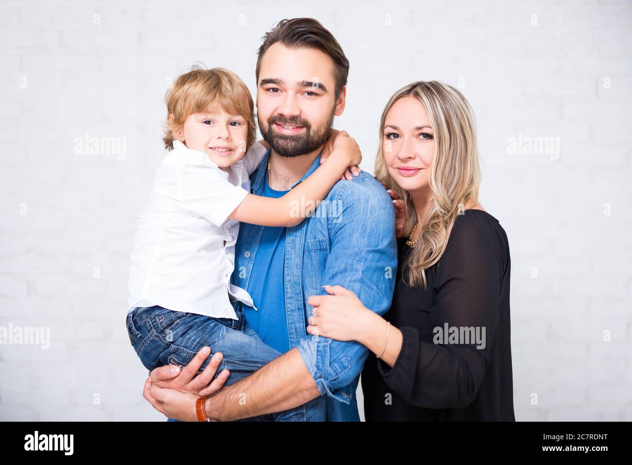 happy family portrait - couple with little son over white background ...