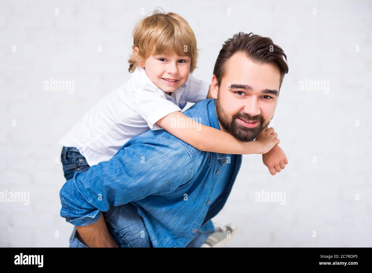 happy family portrait - father with cute little son posing over white ...