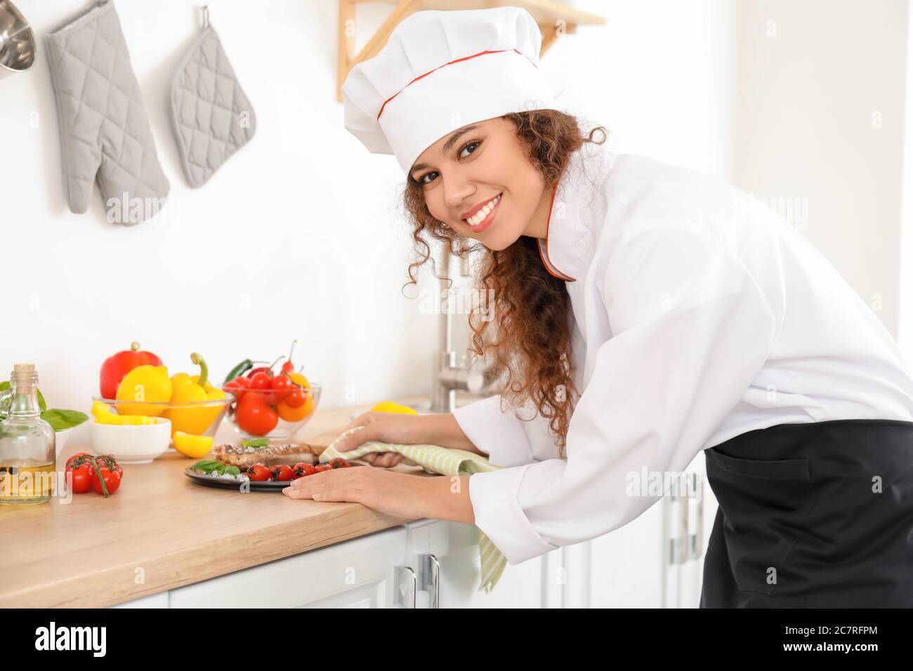 Female African-American chef cooking in kitchen Stock Photo - Alamy