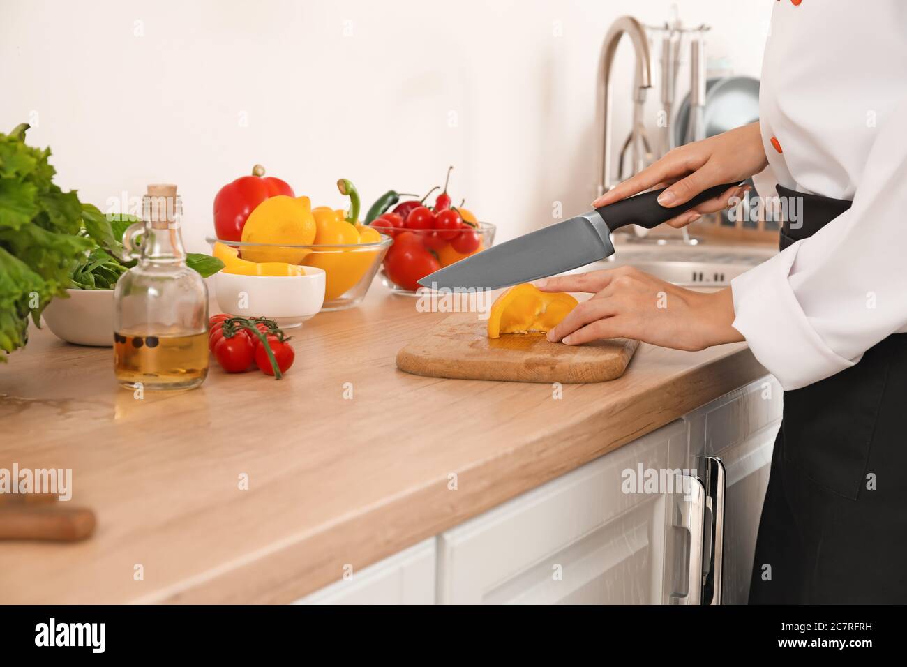 Female African-American chef cooking in kitchen Stock Photo - Alamy