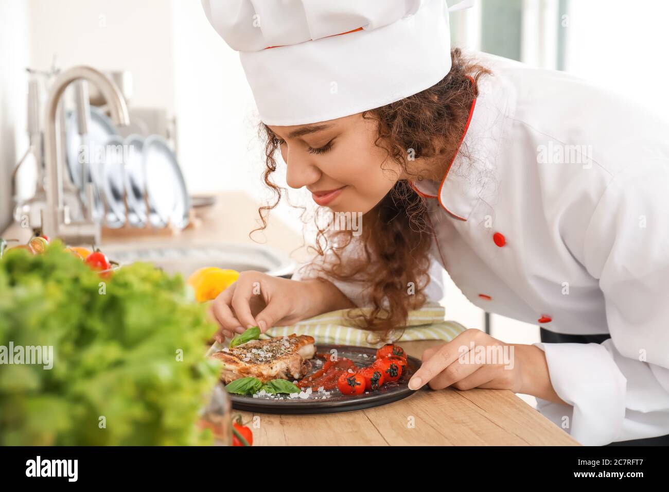 Female African-American chef cooking in kitchen Stock Photo - Alamy