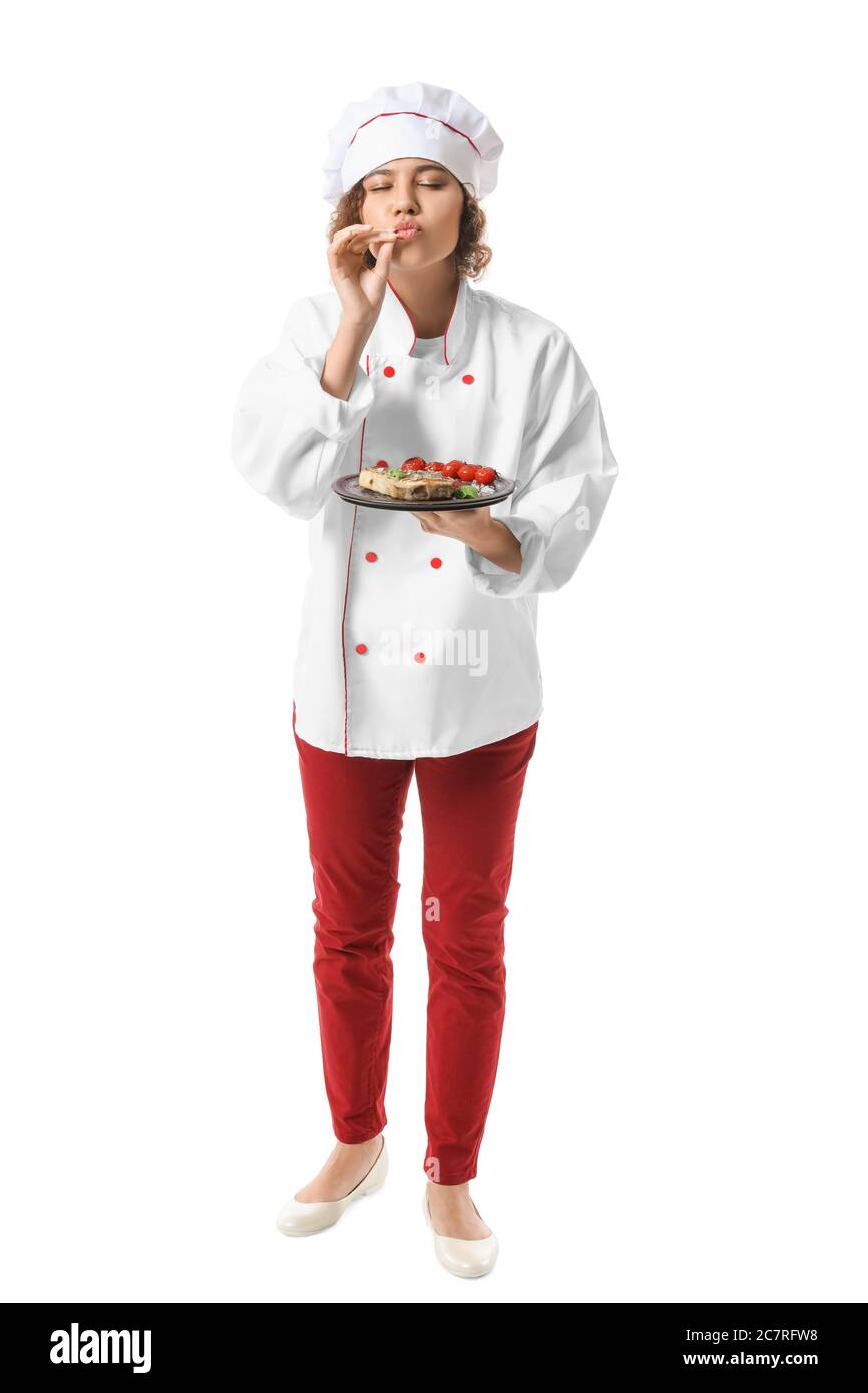 Female African-American chef with tasty dish on white background Stock ...