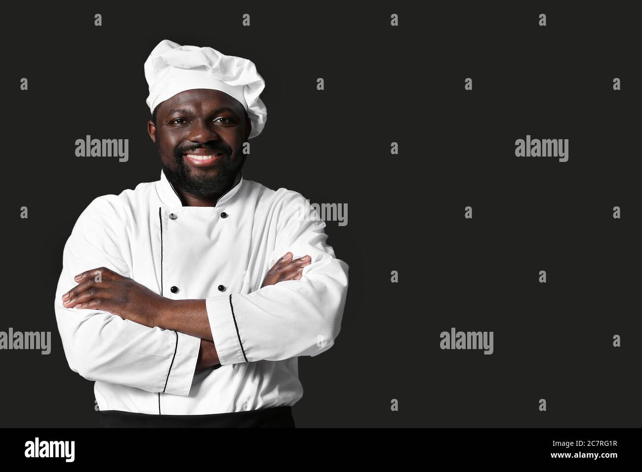 Male African-American chef on dark background Stock Photo - Alamy
