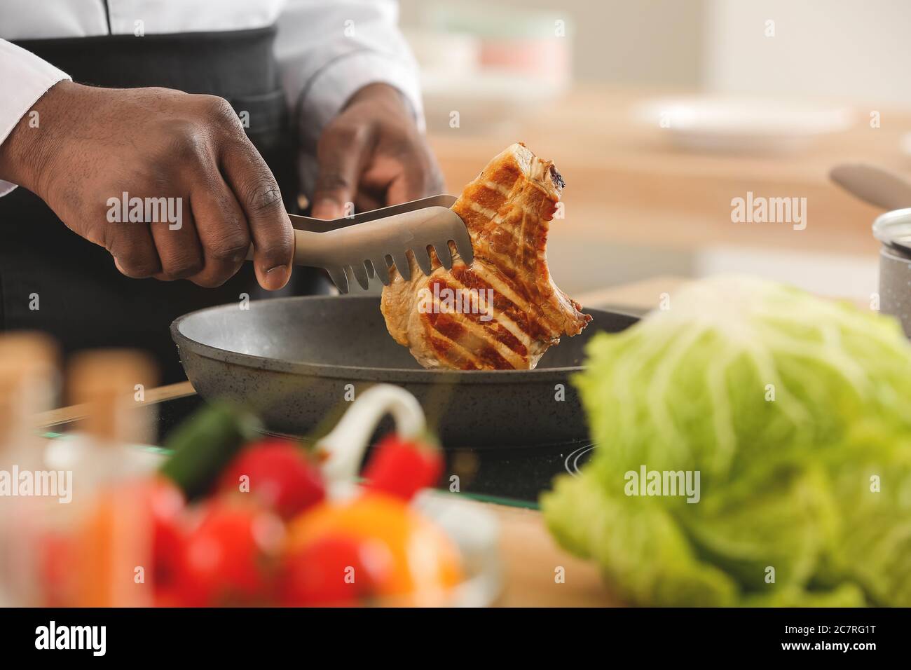 Male African-American chef cooking in kitchen, closeup Stock Photo - Alamy