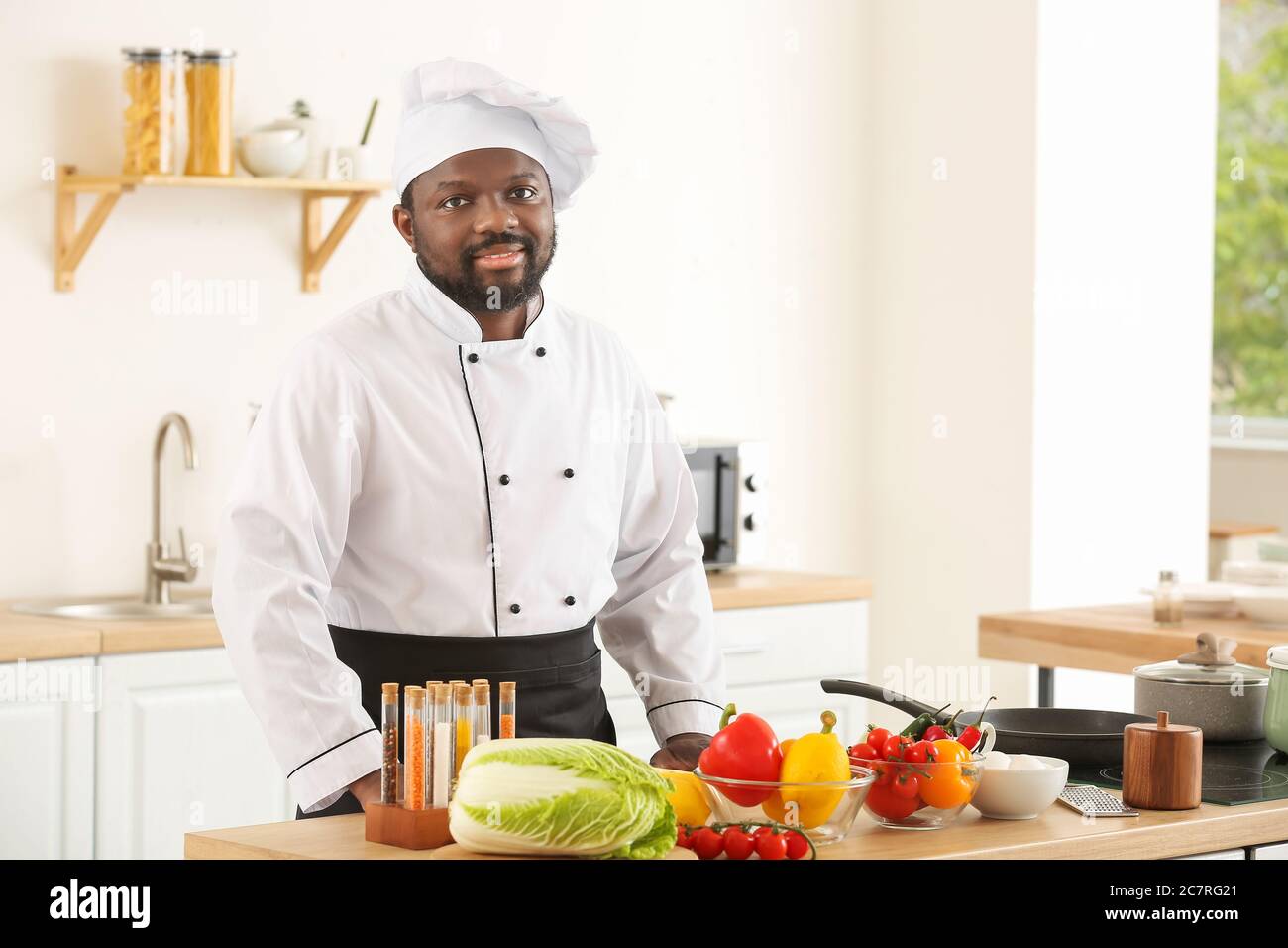 Male African-American chef cooking in kitchen Stock Photo - Alamy
