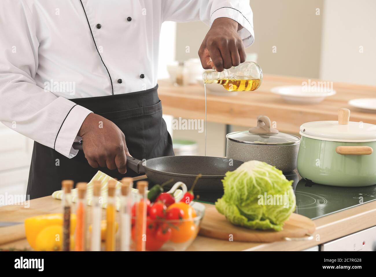 Male African-American chef cooking in kitchen Stock Photo - Alamy