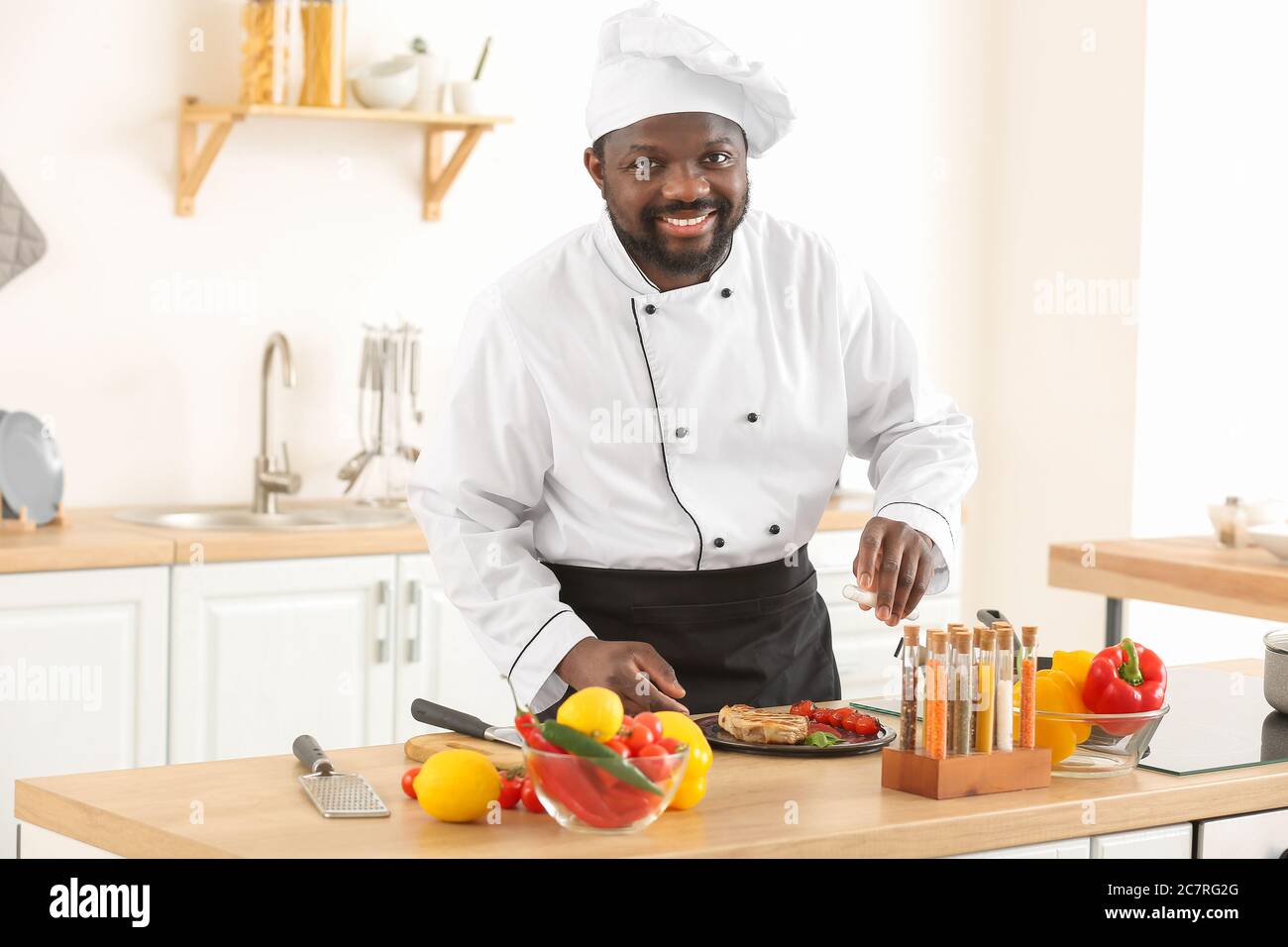 Male African-American chef cooking in kitchen Stock Photo - Alamy