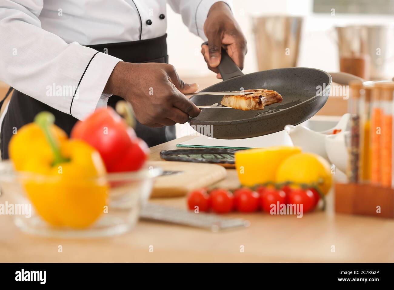 Male African-American chef cooking in kitchen, closeup Stock Photo - Alamy