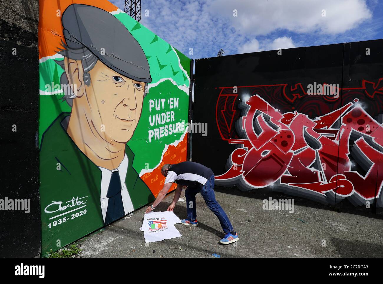 Hugh Dempsey lays a World Cup '94 t-shirt in front of a new mural of ...