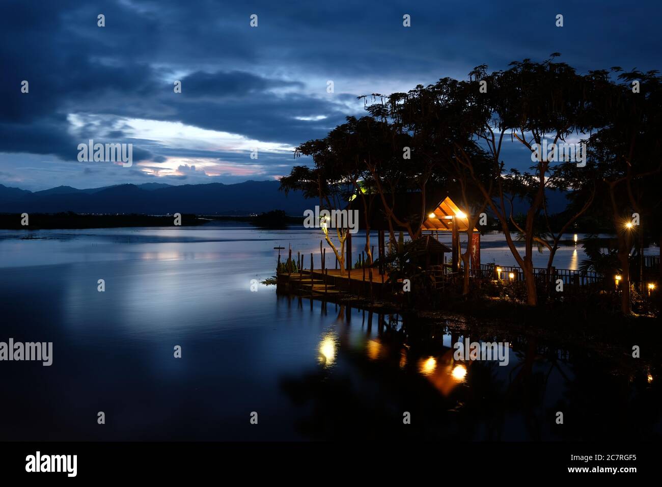 beautiful sunset of Inle lake in Shan State Myanmar. Jetty and trees ...