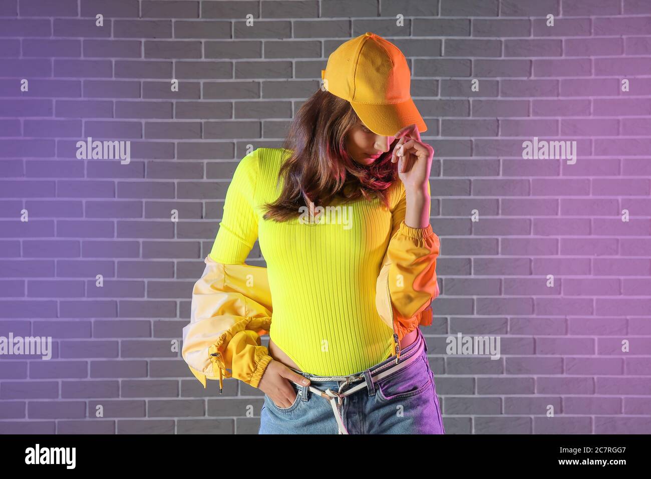 Beautiful female hip-hop dancer against brick wall Stock Photo - Alamy