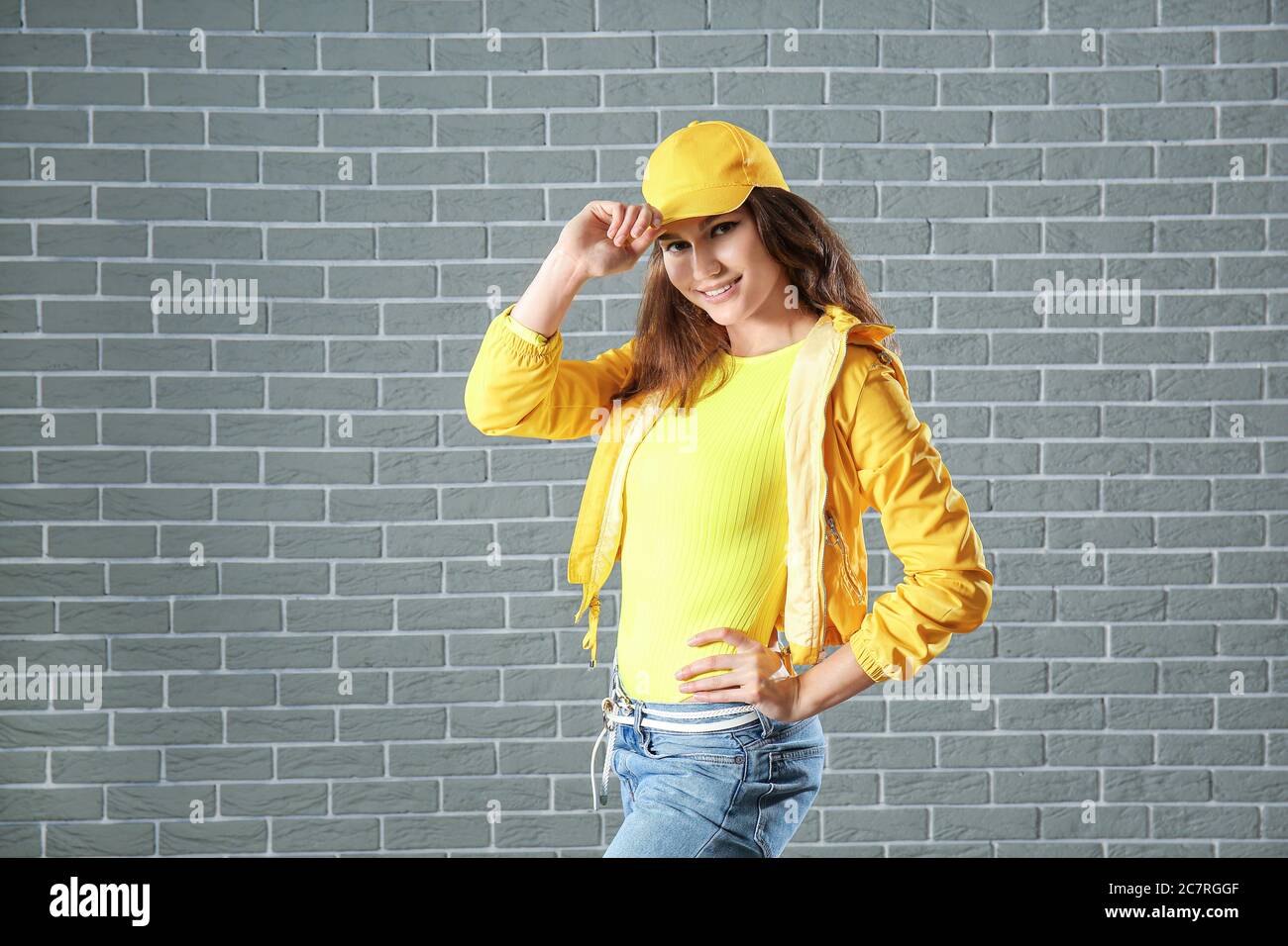Beautiful female hip-hop dancer against brick wall Stock Photo - Alamy