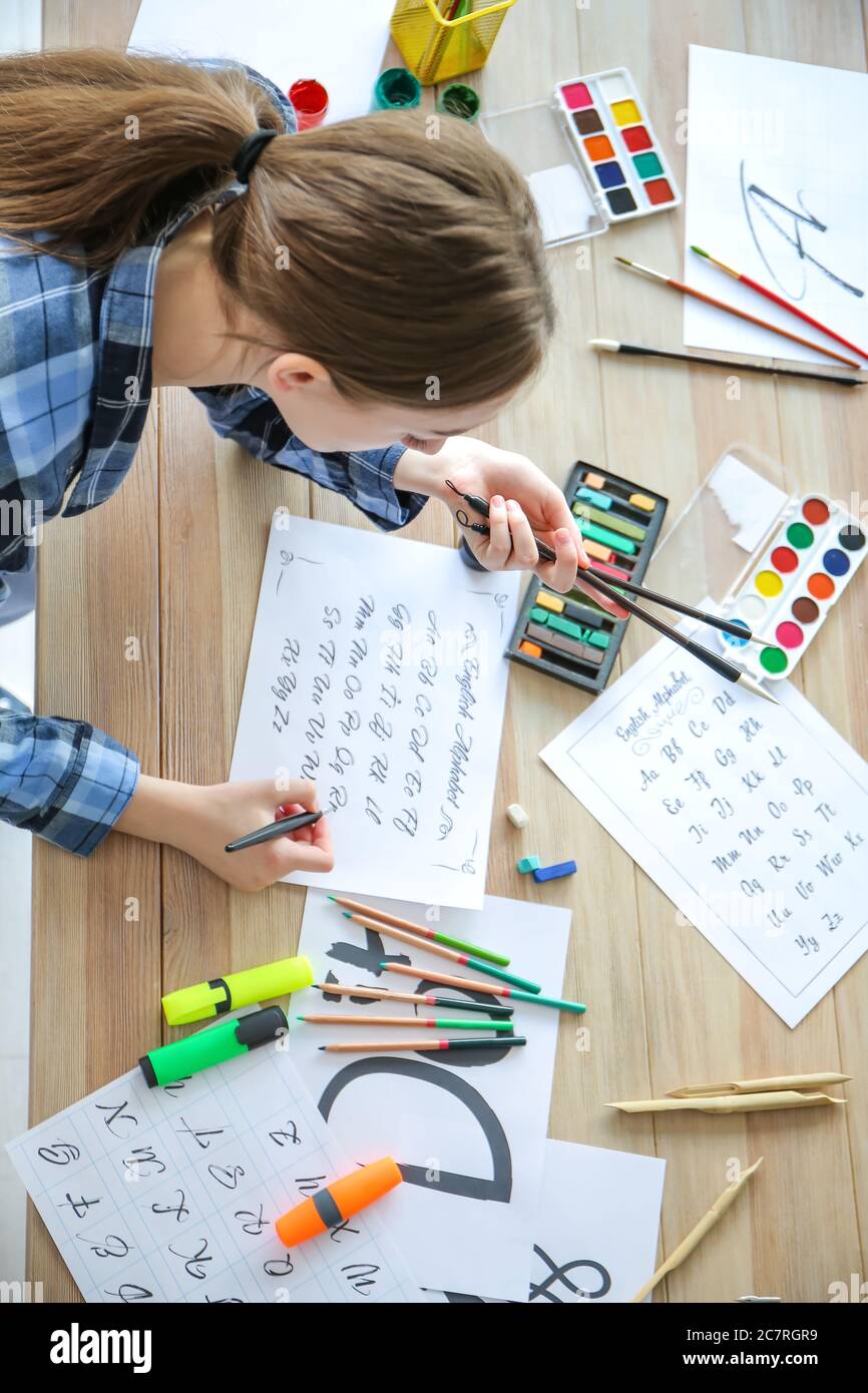 Female calligraphist working in office Stock Photo - Alamy