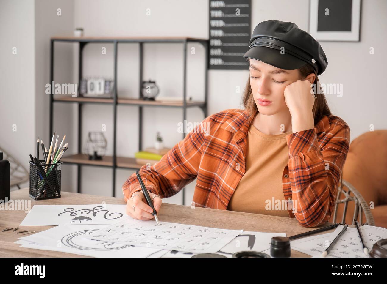 Female calligraphist working in office Stock Photo - Alamy